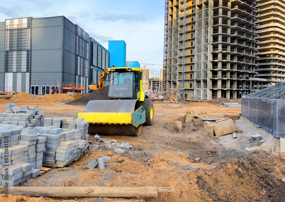 Construction site. Building under construction. Soil Compactor for ...