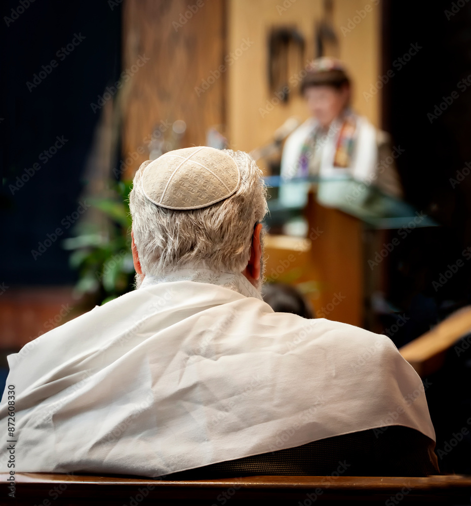 An elderly man with white hair wearing a jewish prayer shawl and a ...