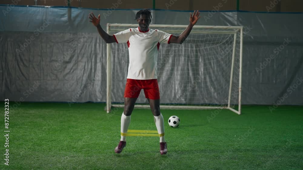 Active workout on soccer field inside sport arena, African player ...