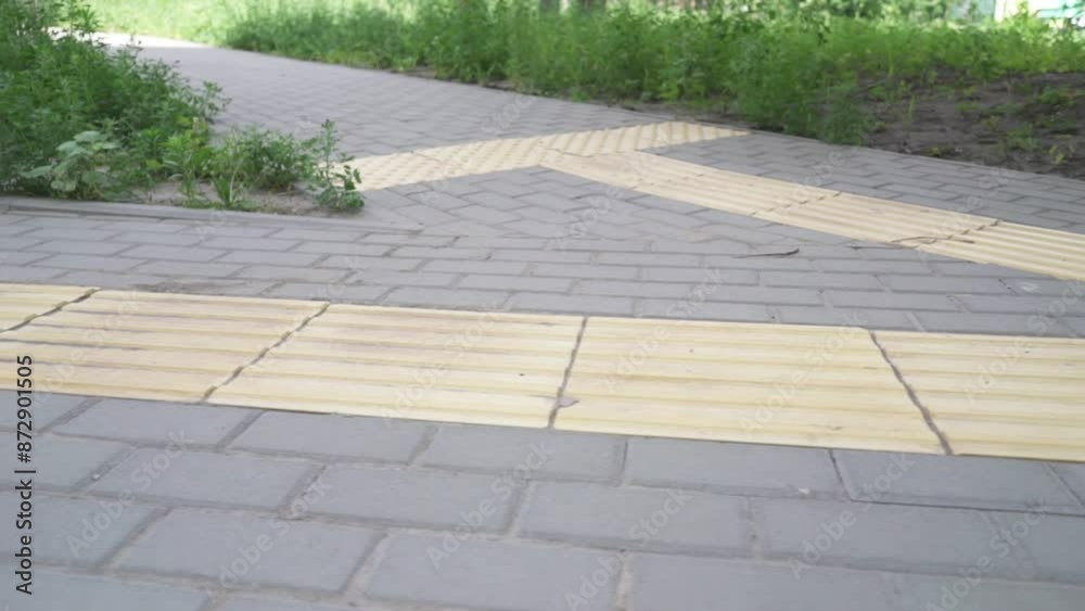 Metropolitan navigation: Elevated view of tactile pavement with braille ...