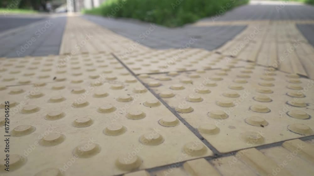 Metropolitan navigation: Elevated view of tactile pavement with braille ...