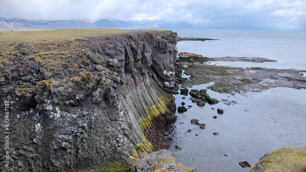 Panoramic view across the basalt cliffs with seagulls and rocks near ...