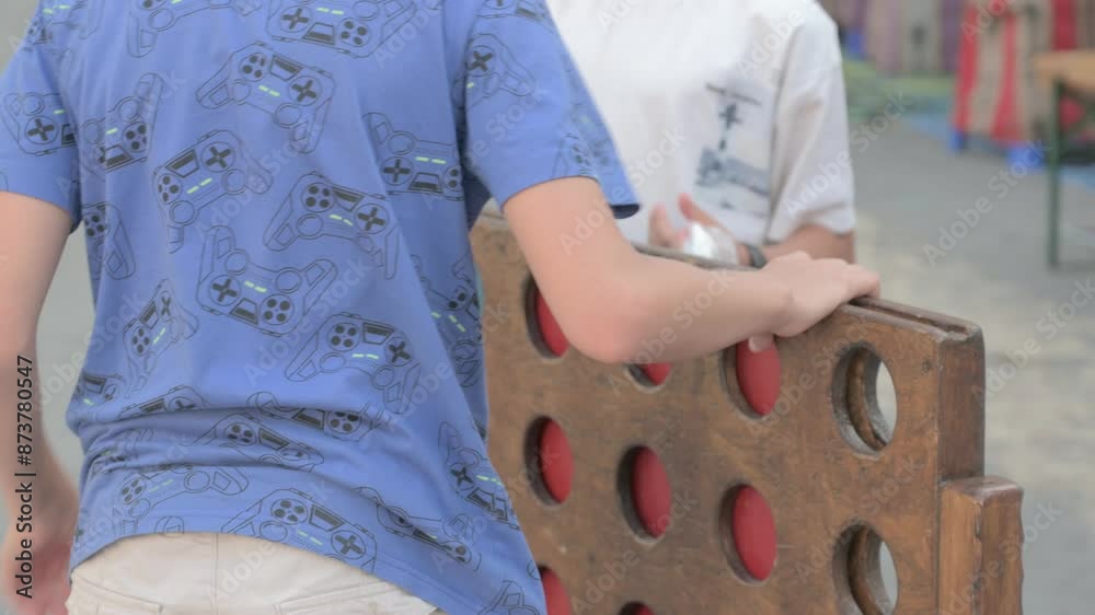 Children playing a giant tic-tac-toe game at a medieval marketplace ...