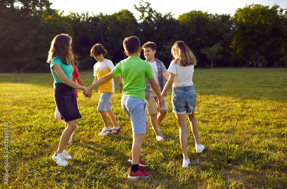 Group of a kids friends playing outside in the park standing in a ...
