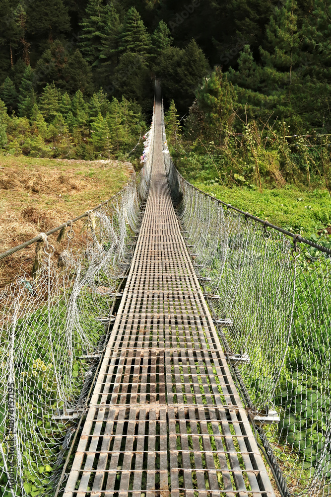 The Benkar-Manjo bridge, a long metal suspension bridge connecting the ...
