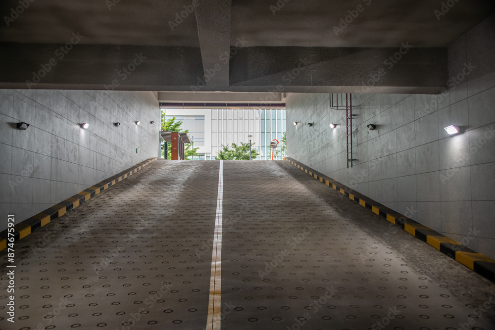 Ramp leading to the underground parking lot of a modern building in the ...