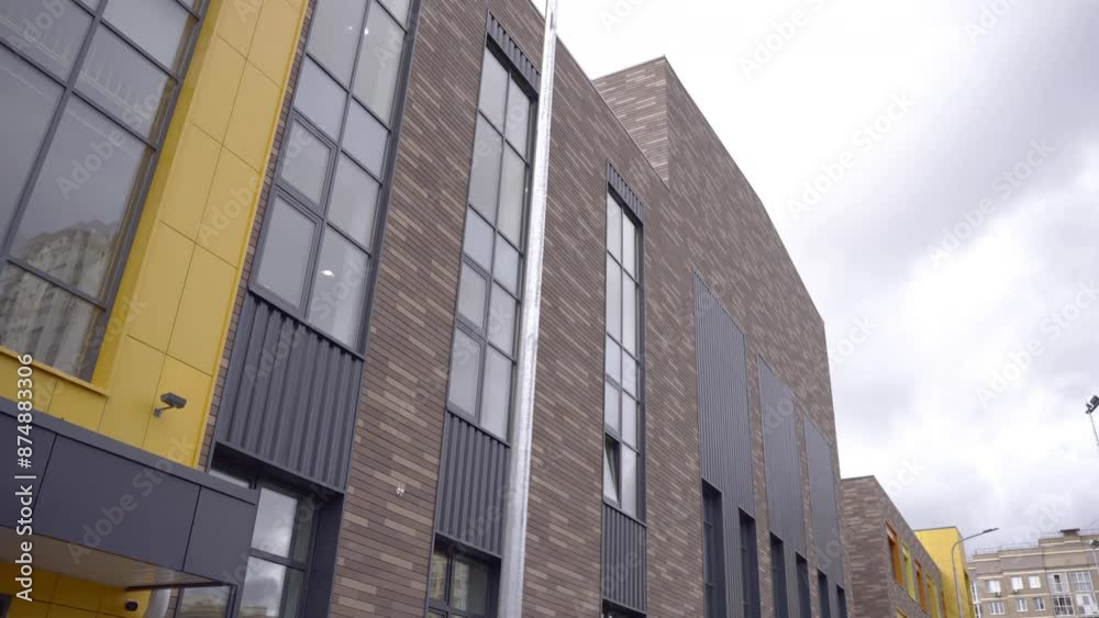 Contemporary facade of school features panoramic windows. Asymmetrical ...