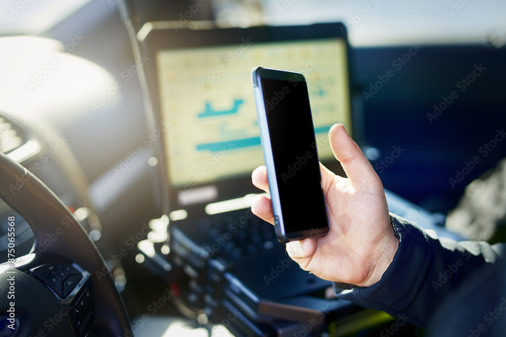 Phone, officer and policeman in car for law, innovation and app with ...