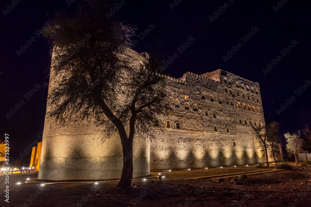 Jabreen citadel fortress stone walls and round bastion tower in night ...