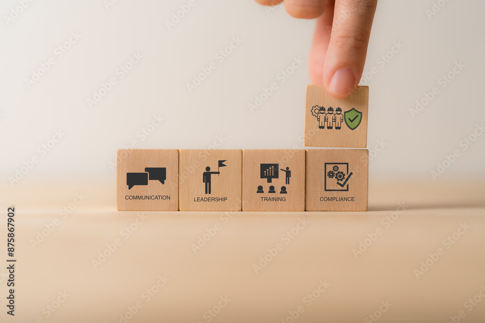 Safety success in the workplace concept. Hand placed wooden cubes with ...