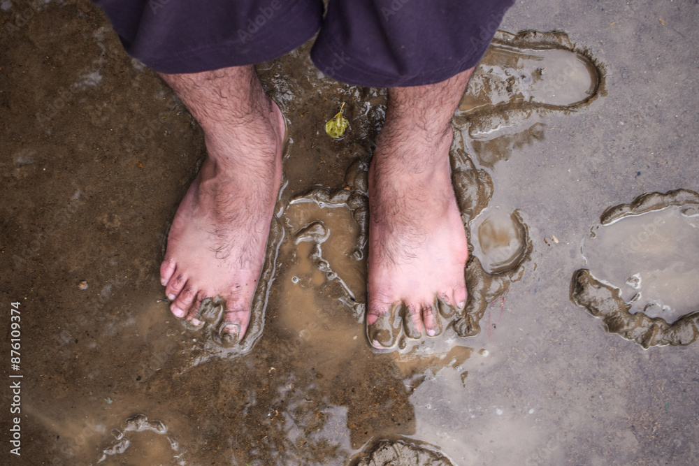 man feet in rain in soil, Bare feet in the mud,legs of farmers wearing ...