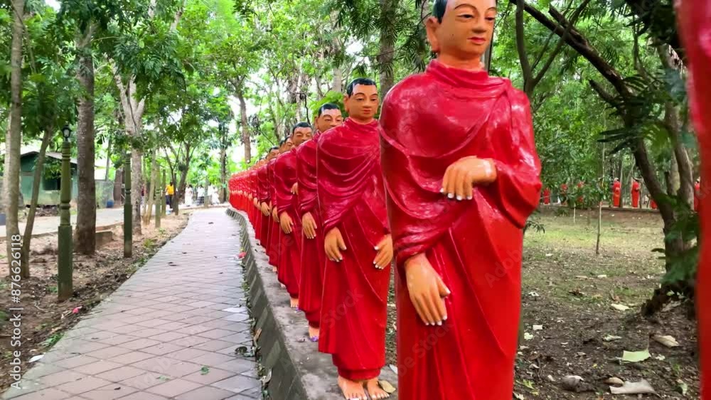 Statues of disciples following the Buddha, depicting a sacred and ...