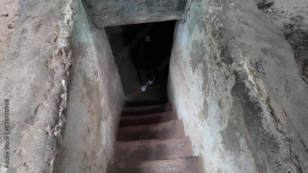 People enter Cu Chi tunnel by step down stairs at tunnels door, tourist ...