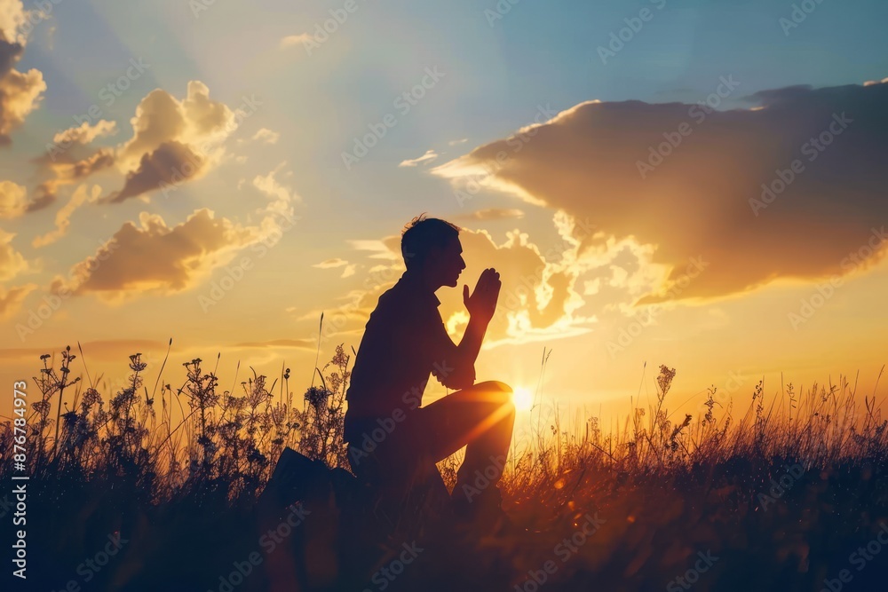 Christian prayer. Man on his knees praying on sunset background ...