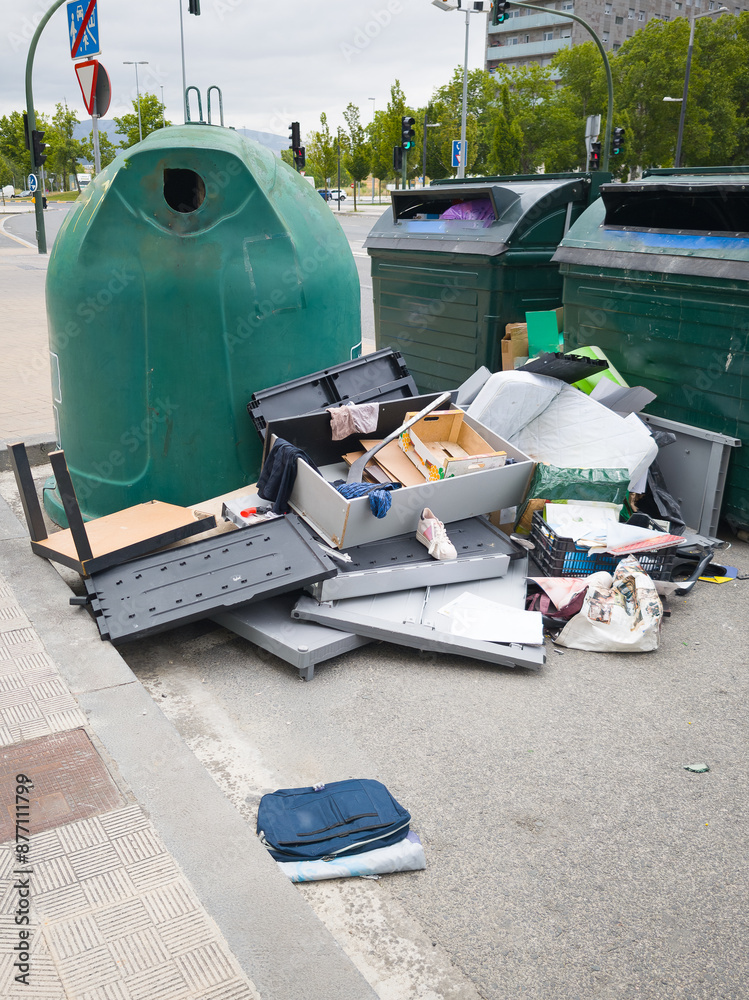 A pile of urban garbage next to full garbage cans. lack of civility ...