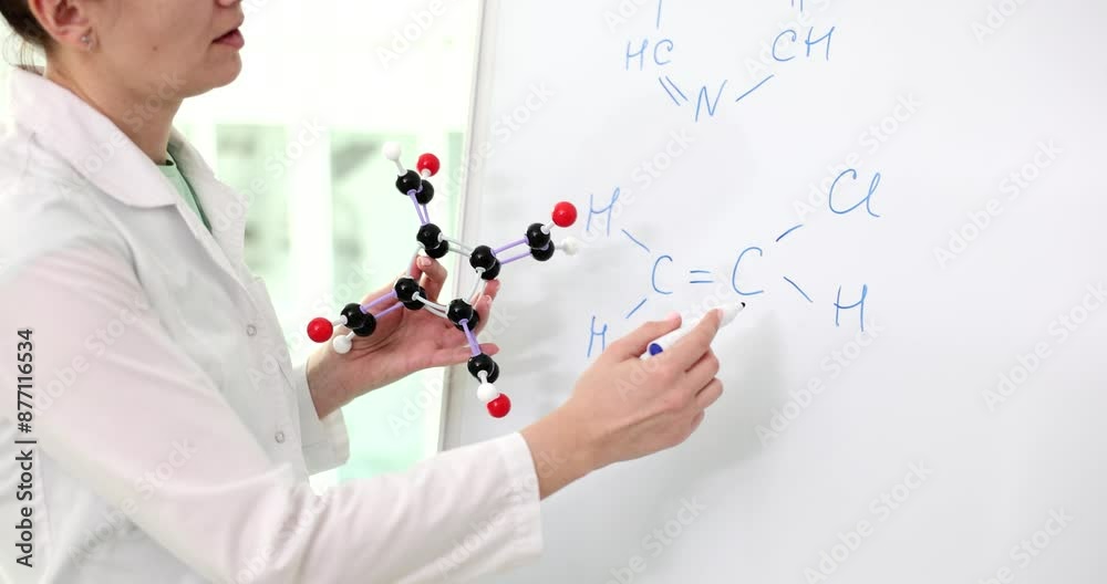 Scientist explains chemical formula written on whiteboard comparing ...