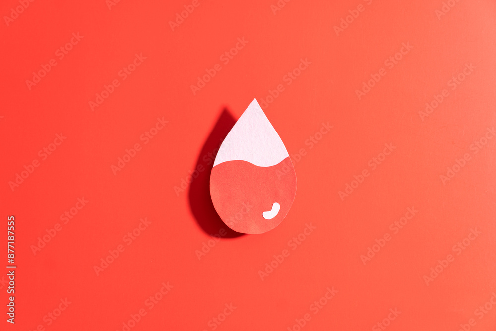 Blood drop with low blood level made from paper on red background ...