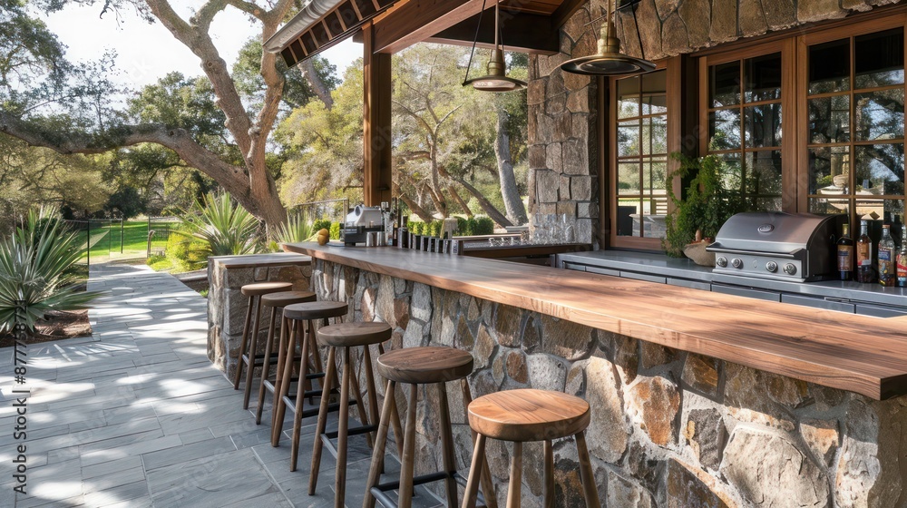 Craftsman-style outdoor bar with wooden stools and a natural stone ...