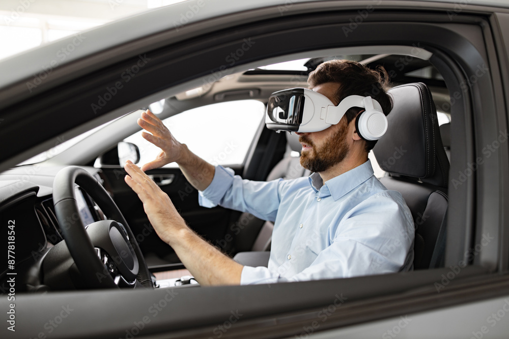 Businessman uses virtual reality headset while sitting inside vehicle ...