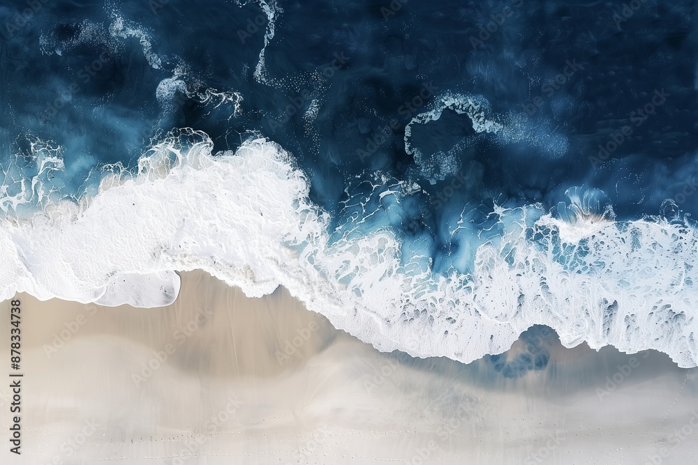 Stunning aerial perspective of dark blue ocean waves crashing onto a ...
