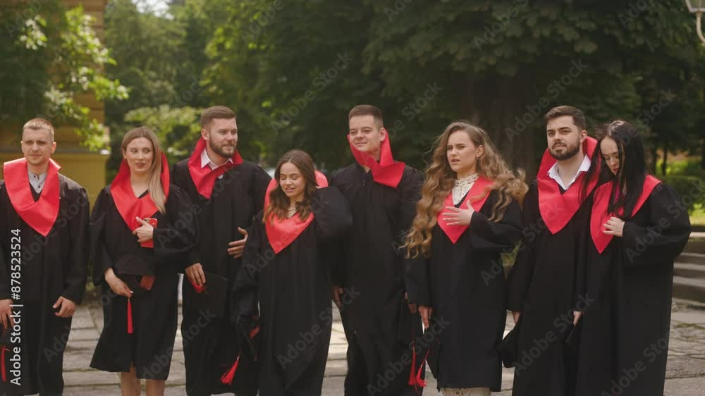 Students celebrate graduation. Young people dressed in gowns and ...