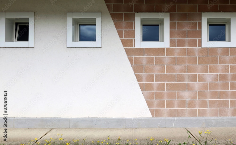 House exterior wall divided among a white plaster side and the other ...