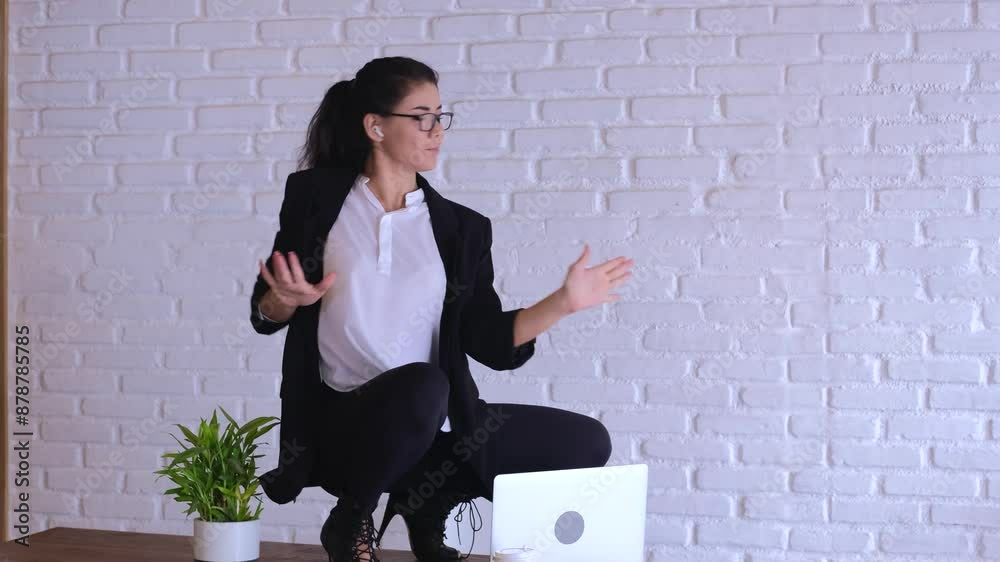 Female office worker performs spontaneous dance on desk. Energetic ...