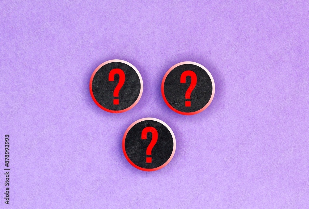 round stick with three red question marks. the concept of question or ...