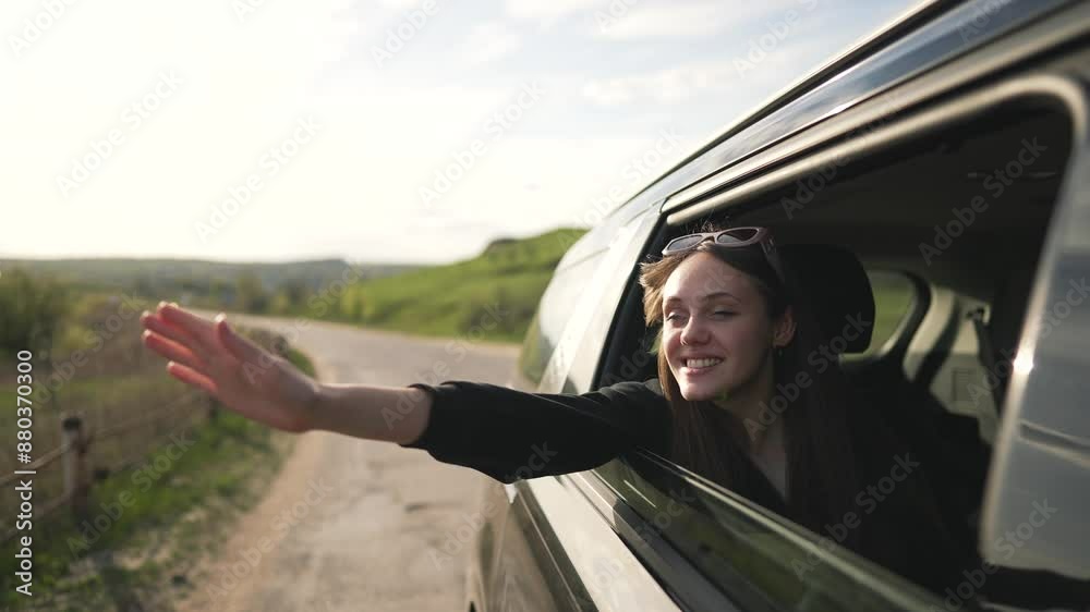woman reaches out her hand outside window. Woman feels open air ...