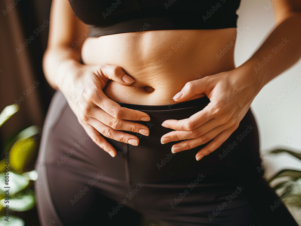 Fat belly of a woman. female hand of excessive fat on the belly. diet ...