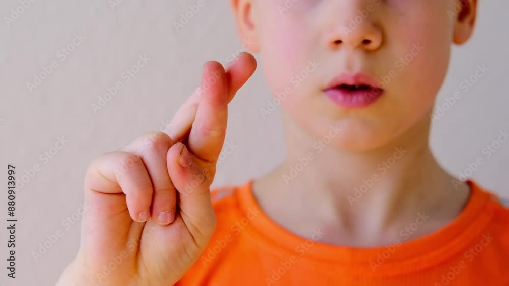 Close-up of child's crossed fingers for luck, 9-year-old boy making ...