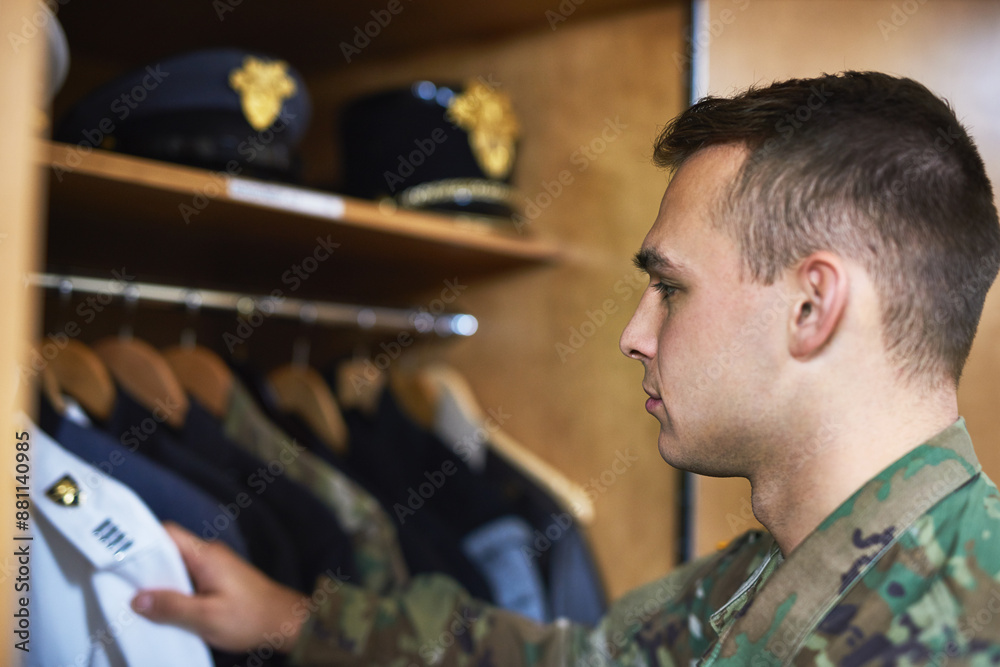 Man, soldier and choice for clothes in closet with badge, gear and ...