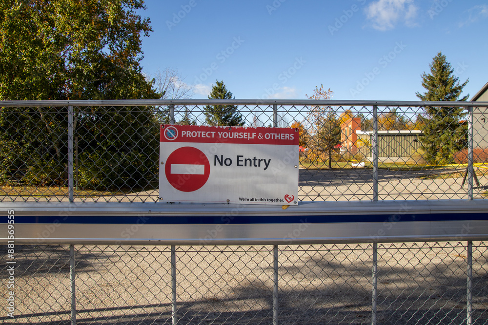 Red and white No Entry sign - metal fence backdrop - clear prohibition ...