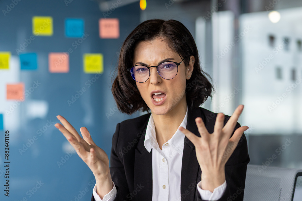 Angry businesswoman with glasses expressing frustration in office ...