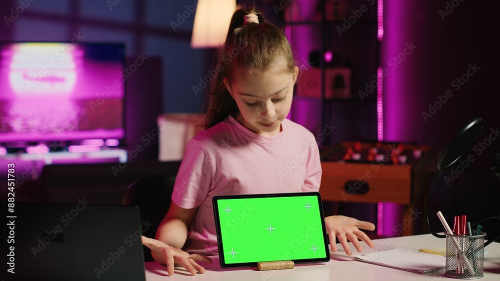 Cute child content creator filming technology review of newly released ...