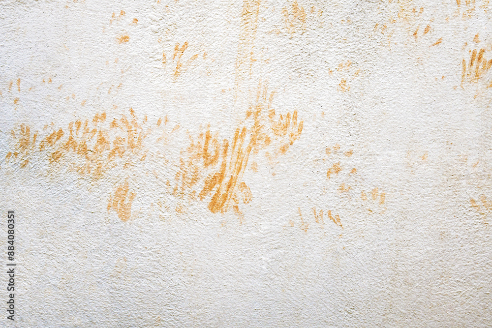 Dirty old uneven render concrete wall with cat footprint red soil ...