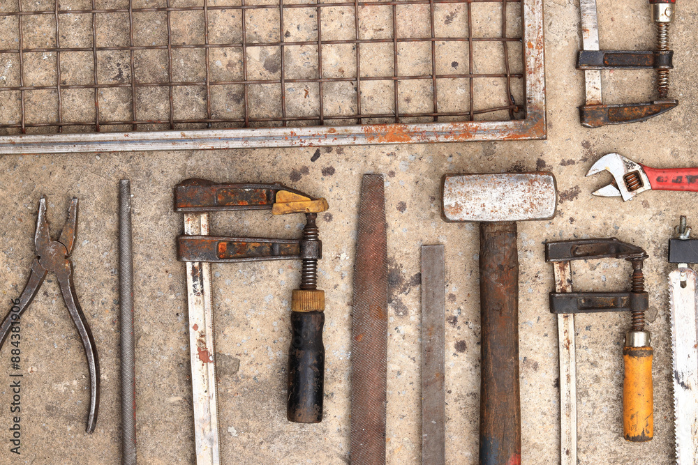 Old construction tools laid out on a concrete background, top view ...