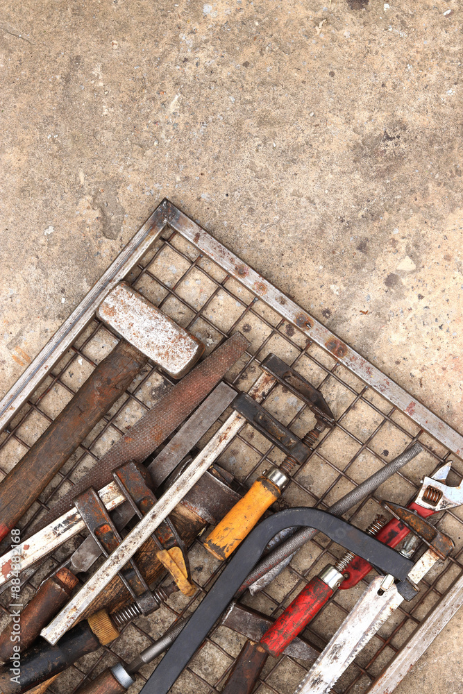 Old construction tools laid out on a concrete background, top view ...