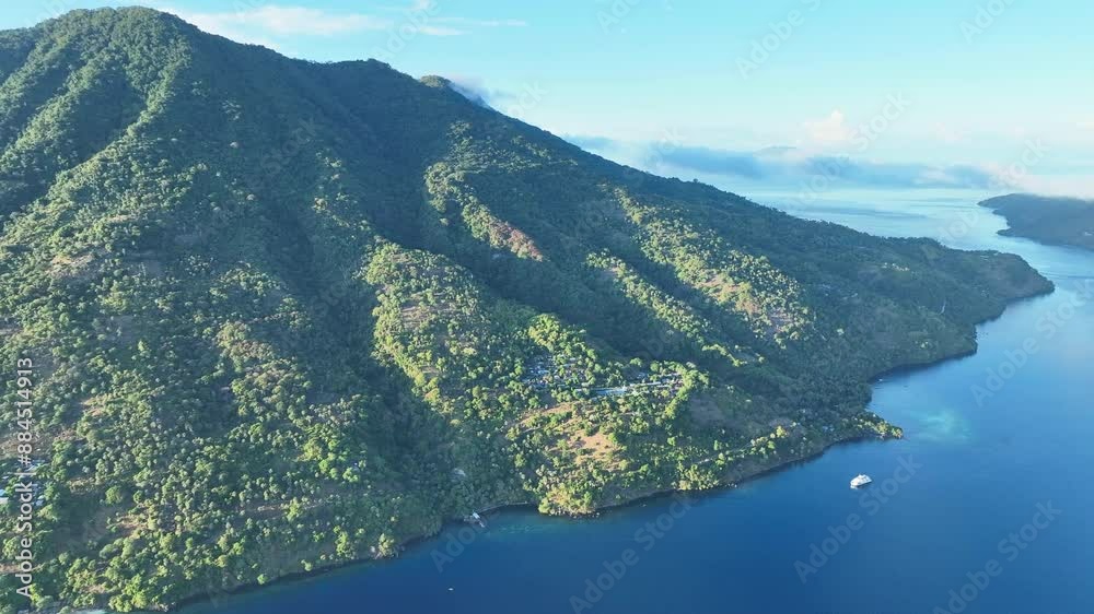 Pulau Pura, a scenic volcano, sits in the middle of the Pantar Strait ...