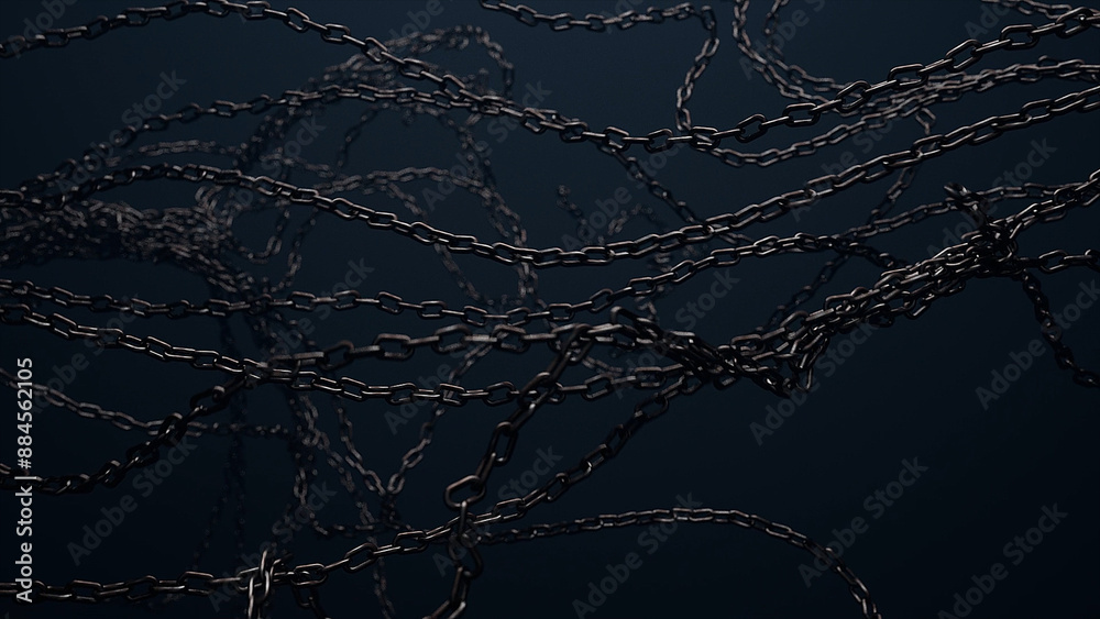 Intertwined black metal chains hang in front of a dark background ...