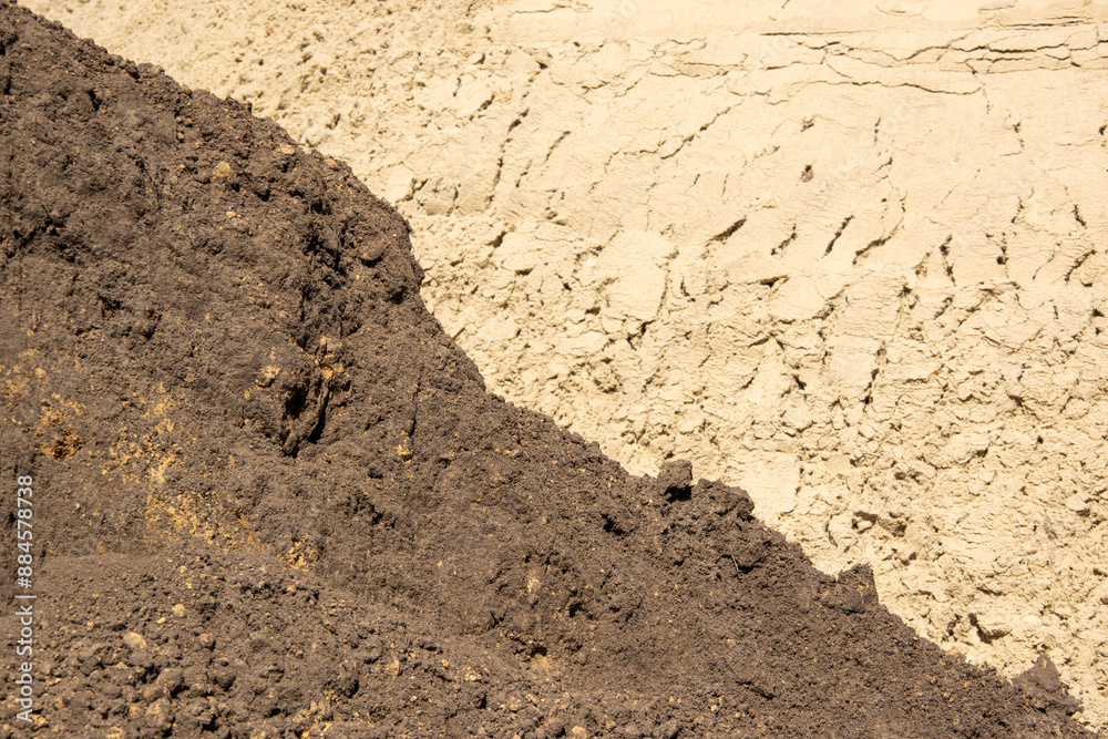 A close-up photo of the surface of two different types of soil. One ...