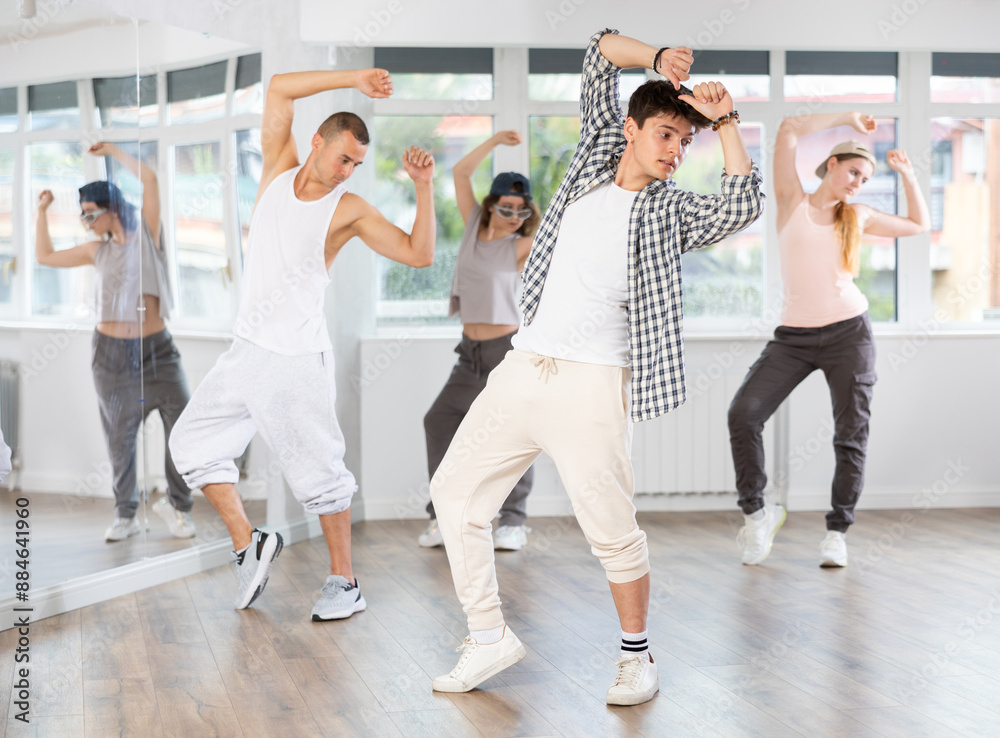 During hip hop dance lesson, guy leads, conducts classes, teaches ...
