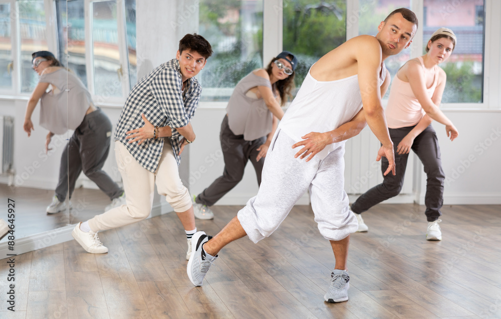 During hip hop dance lesson, guy leads, conducts classes, teaches ...