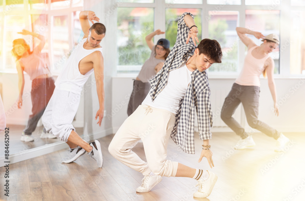 During hip hop dance lesson, guy leads, conducts classes, teaches ...
