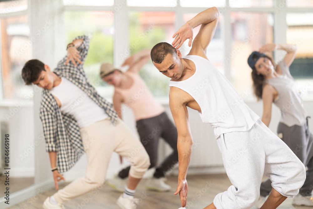 During hip hop dance lesson, guy leads, conducts classes, teaches ...