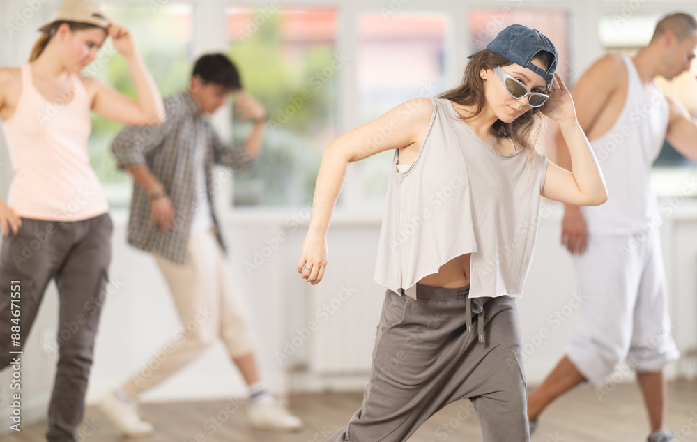 During hip hop dance lesson, girl leads, conducts classes, teaches ...