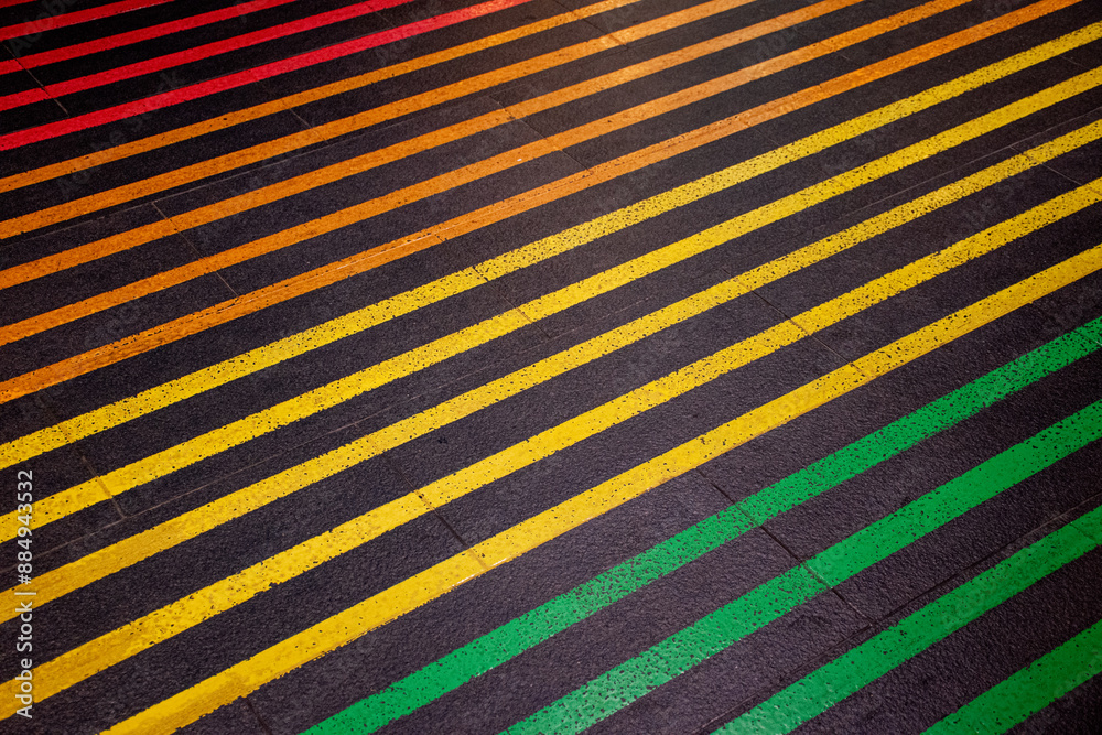 Colorful lines on the black floor and walkway. Crossing the street on a ...