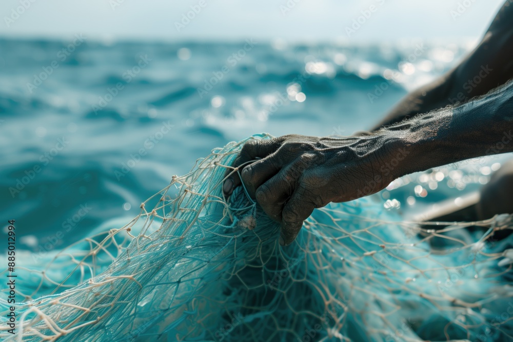 Fisherman mending fishing nets on a boat with the ocean in the ...