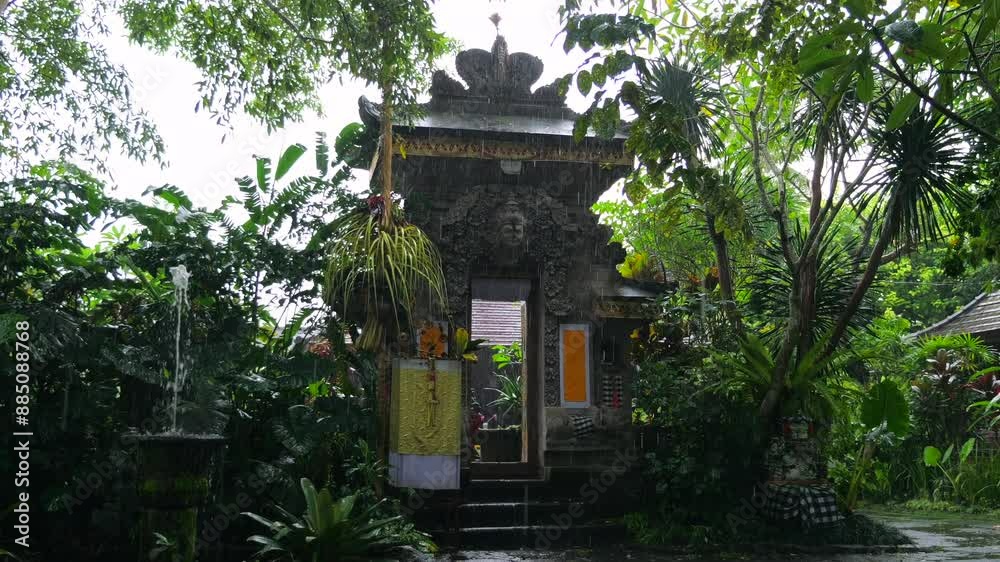 Traditional Bali temple under curtain heavy rain. Rain creates mystical ...