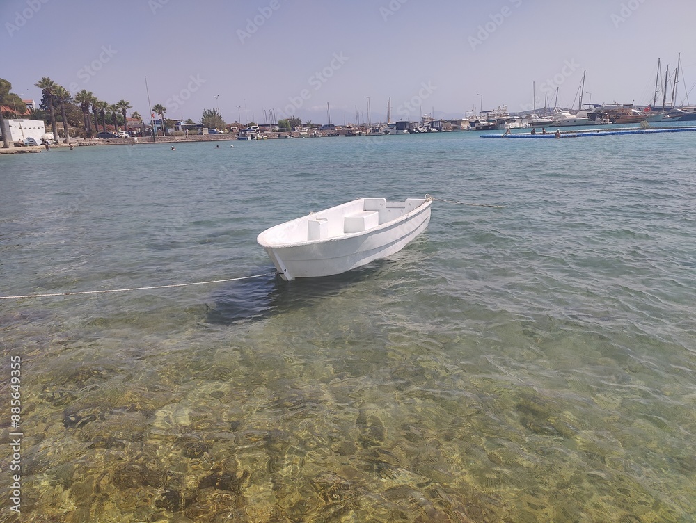 The image shows a small white boat with a single outboard motor ...